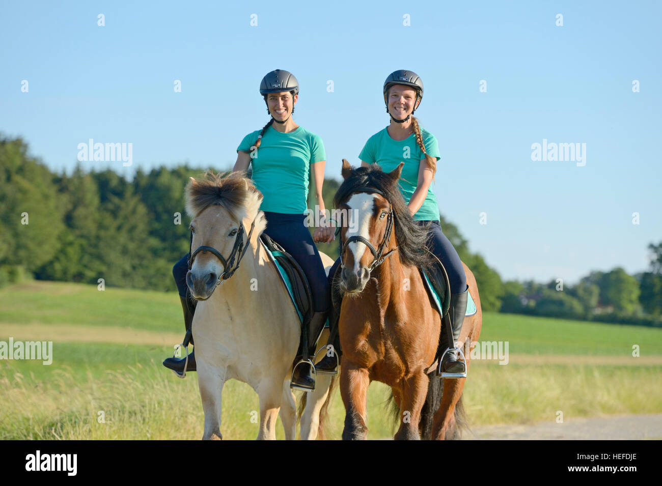 Two girls on ponies riding hi-res stock photography and images - Alamy