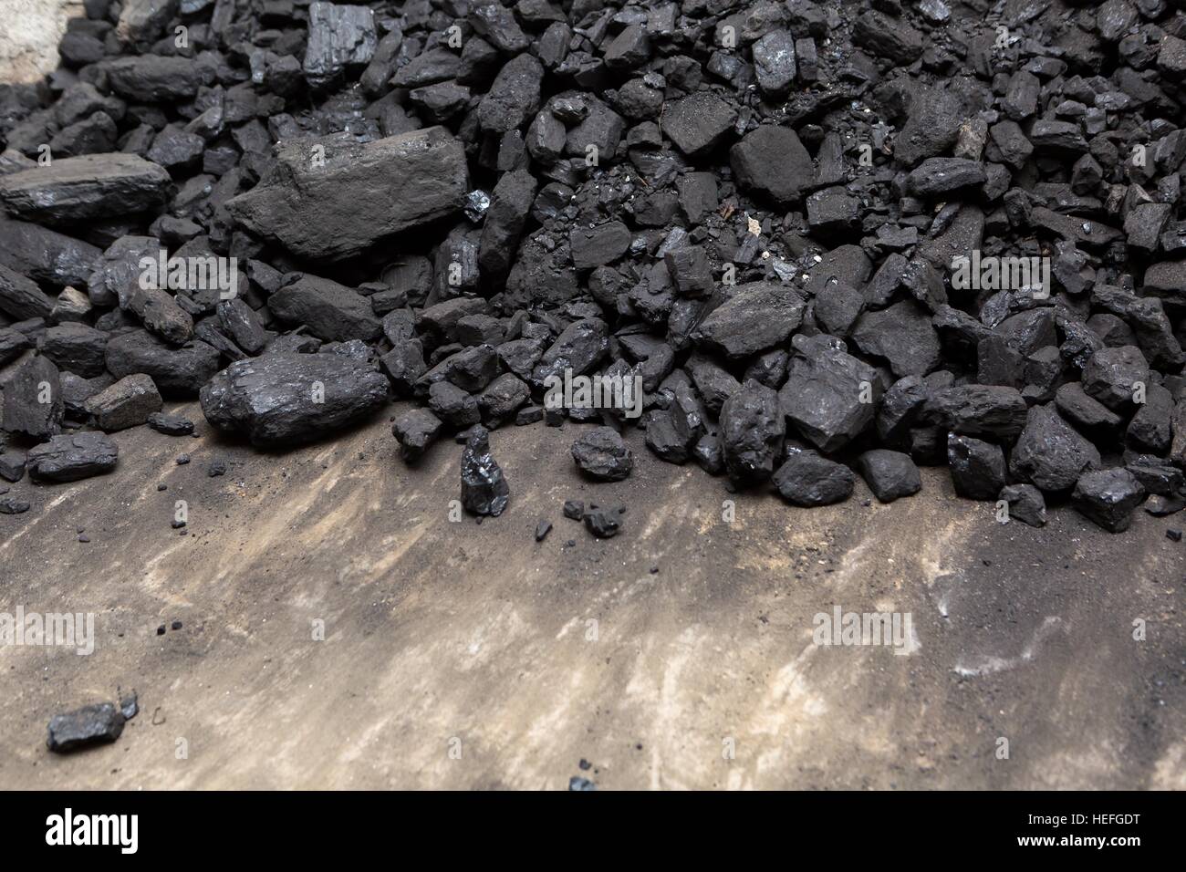 Black coal lying on a pile in house basement. Fuel material Stock Photo ...