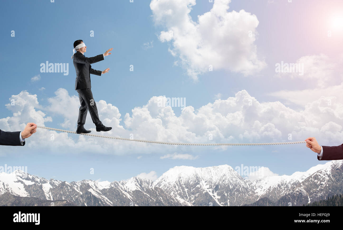 Business concept of risk support and assistance with man balancing on ...