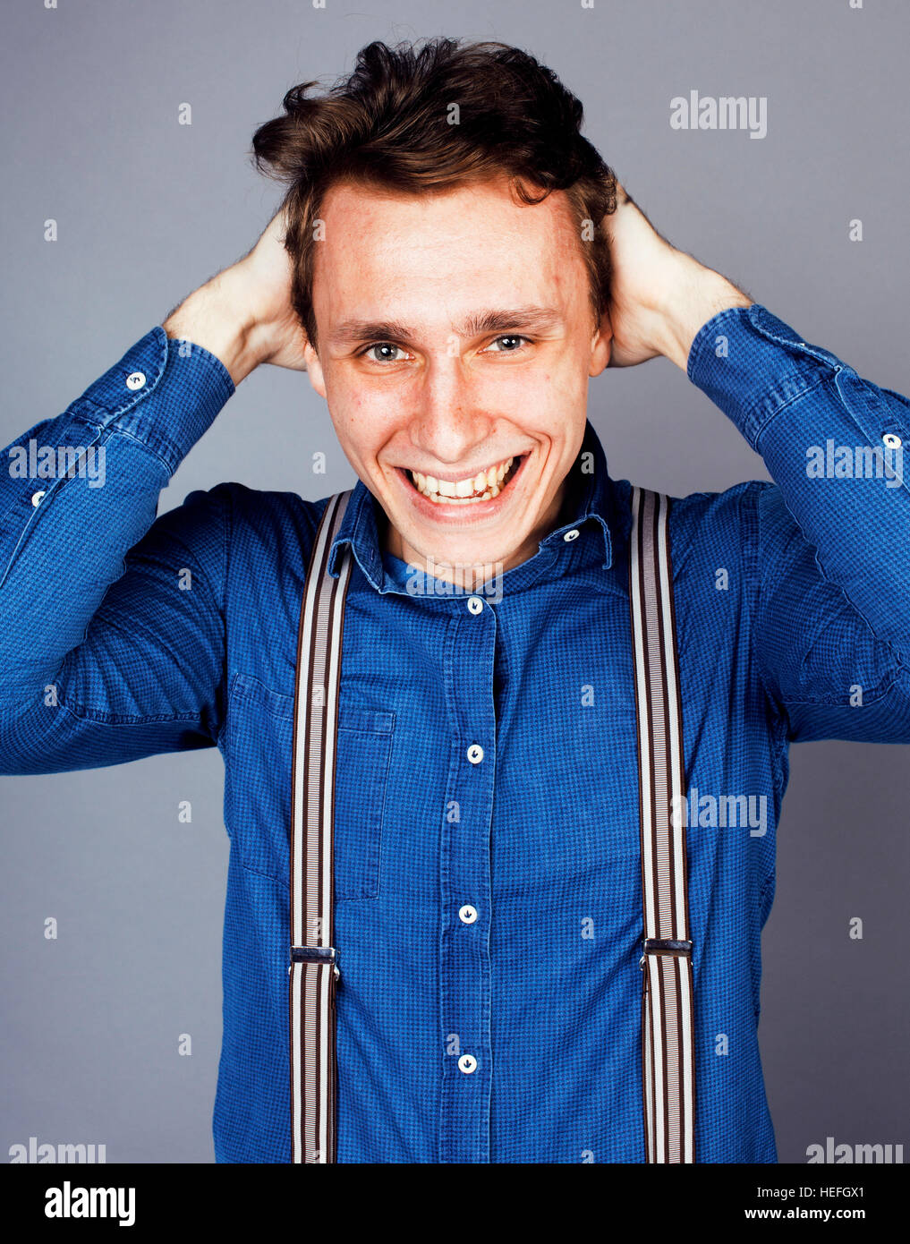 young goofy man with pimples pointing in studio Stock Photo - Alamy