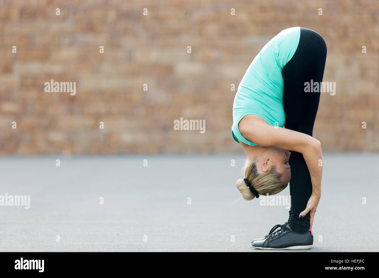 Standing forward bend pose Stock Photo - Alamy