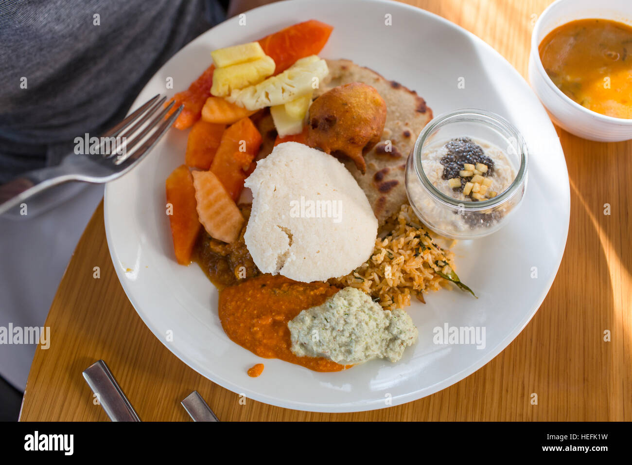 Delicious breakfast consisting an assortment of Idli,fresh fruit ...