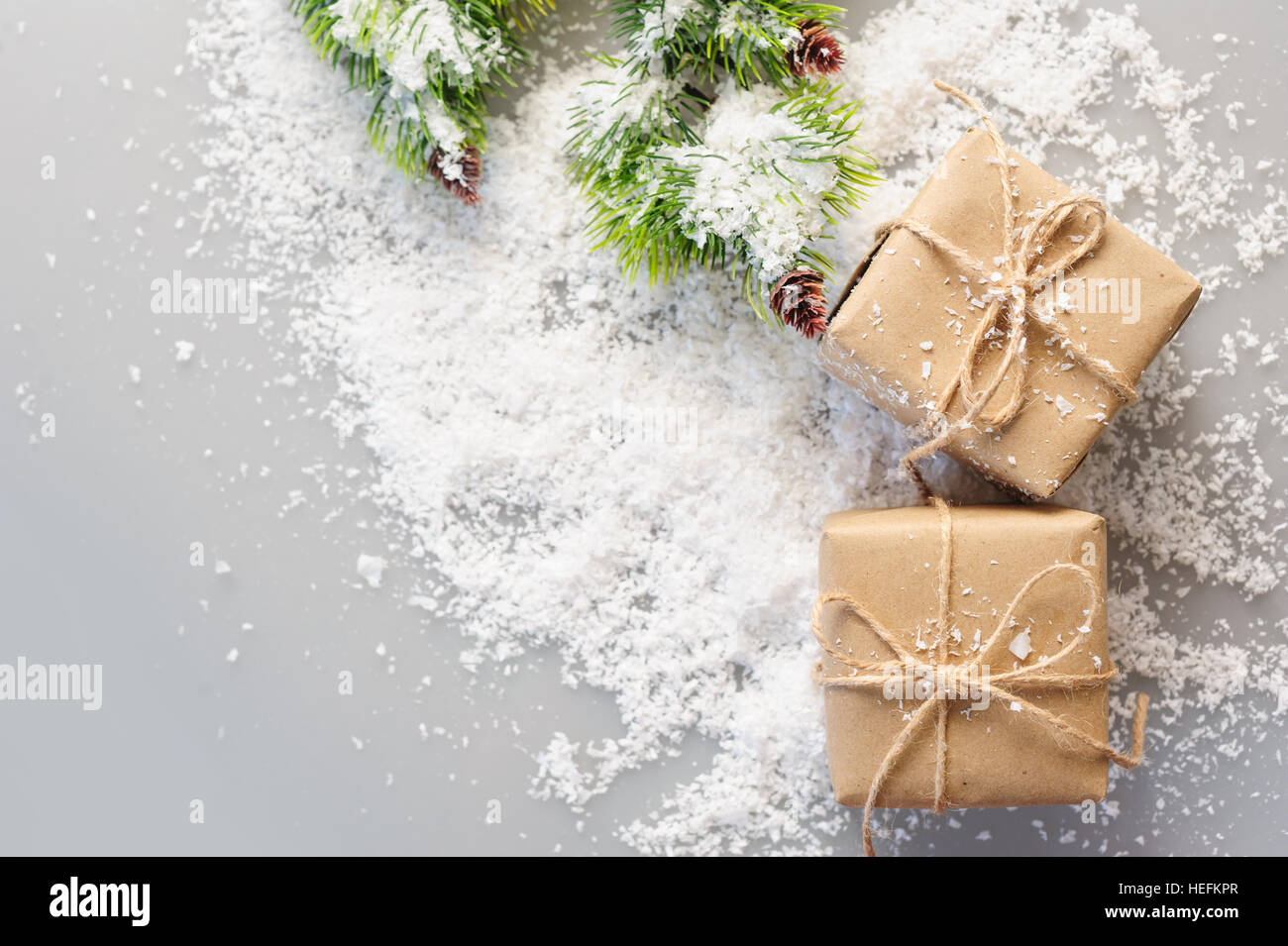 gift boxes and fir branches on artificial snow Stock Photo - Alamy