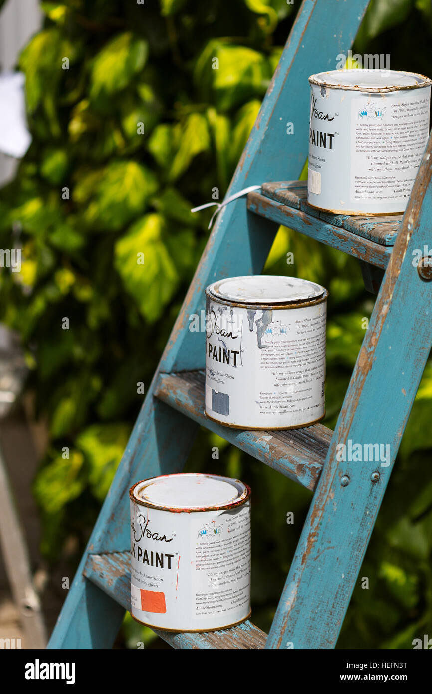 Tins of paint on step ladder for home decorating Stock Photo - Alamy