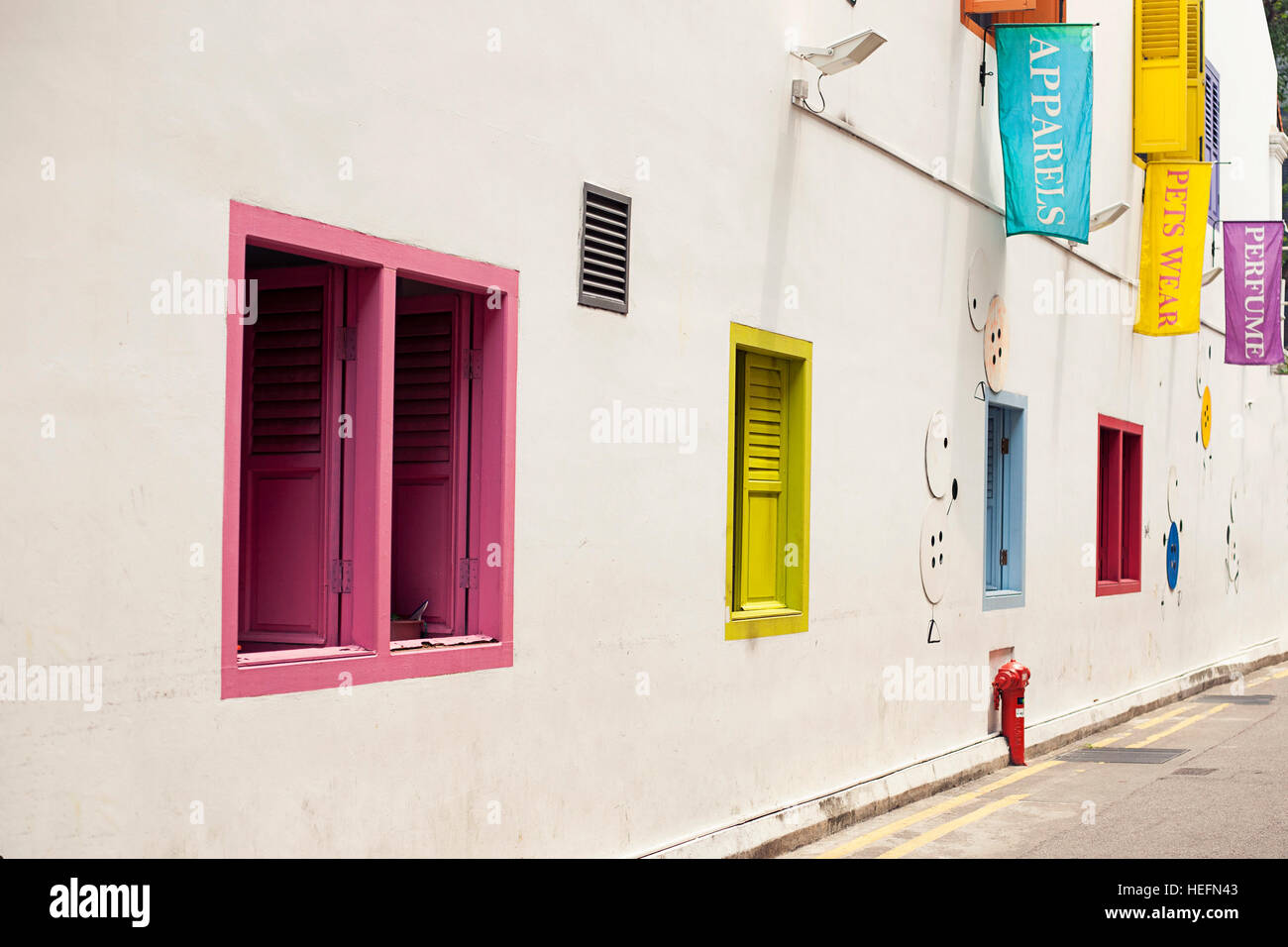 White wall with colorful windows Stock Photo - Alamy