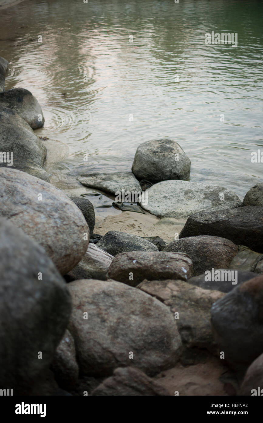 The river flows around stones Stock Photo - Alamy