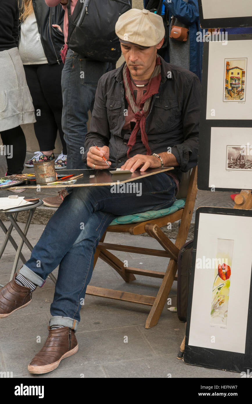 Male artist preparing paintings on street, Florence, Tuscany, Italy ...