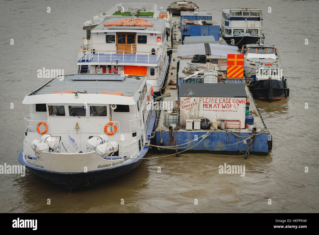 Boats and pontoon on the Thames, London, seen from Waterloo Bridge ...