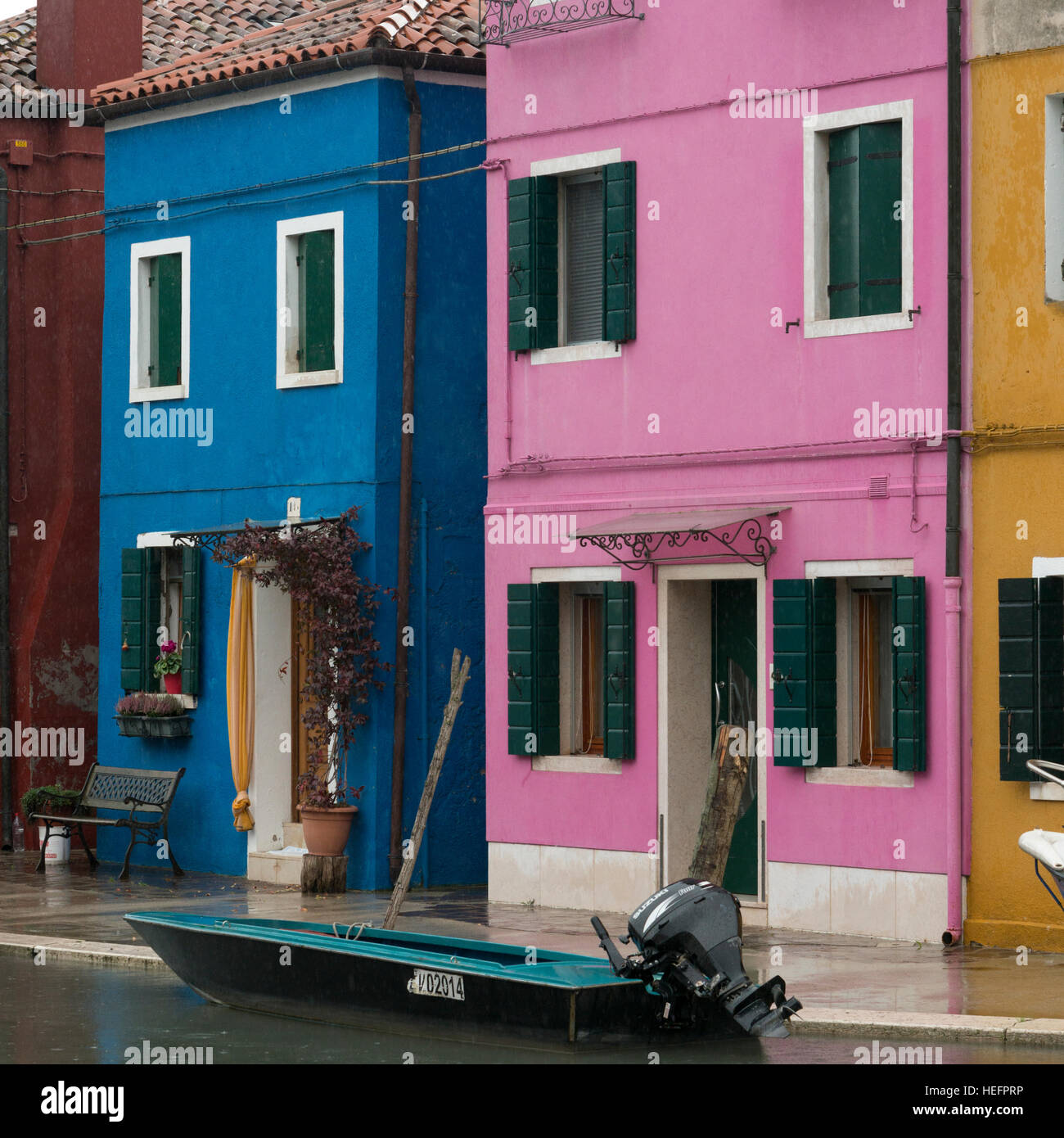 Colorful houses by canal with motorboat, Burano, Venice, Veneto, Italy ...