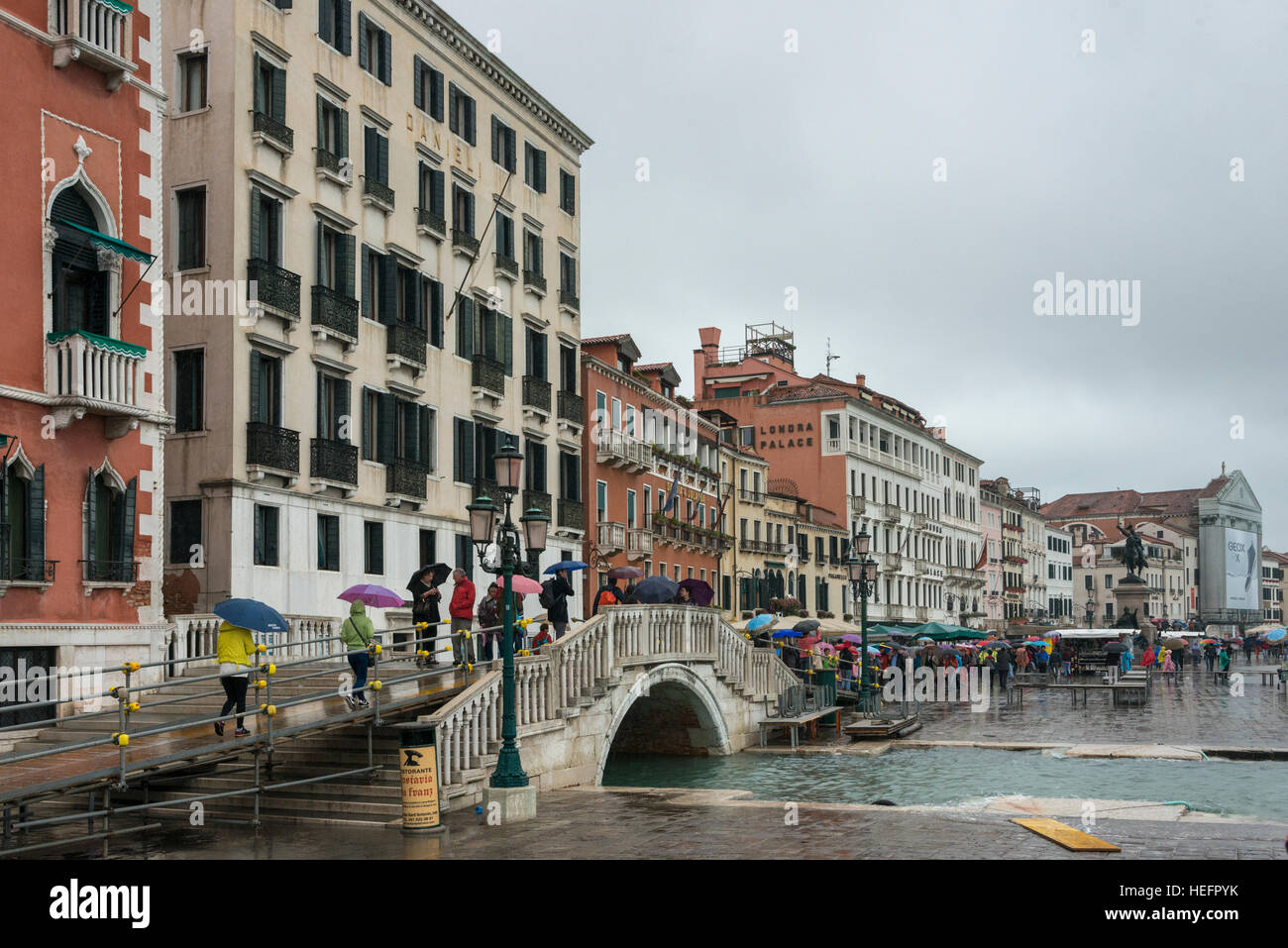 People walking on footbridge in the rain, Castello, Venice, Veneto ...