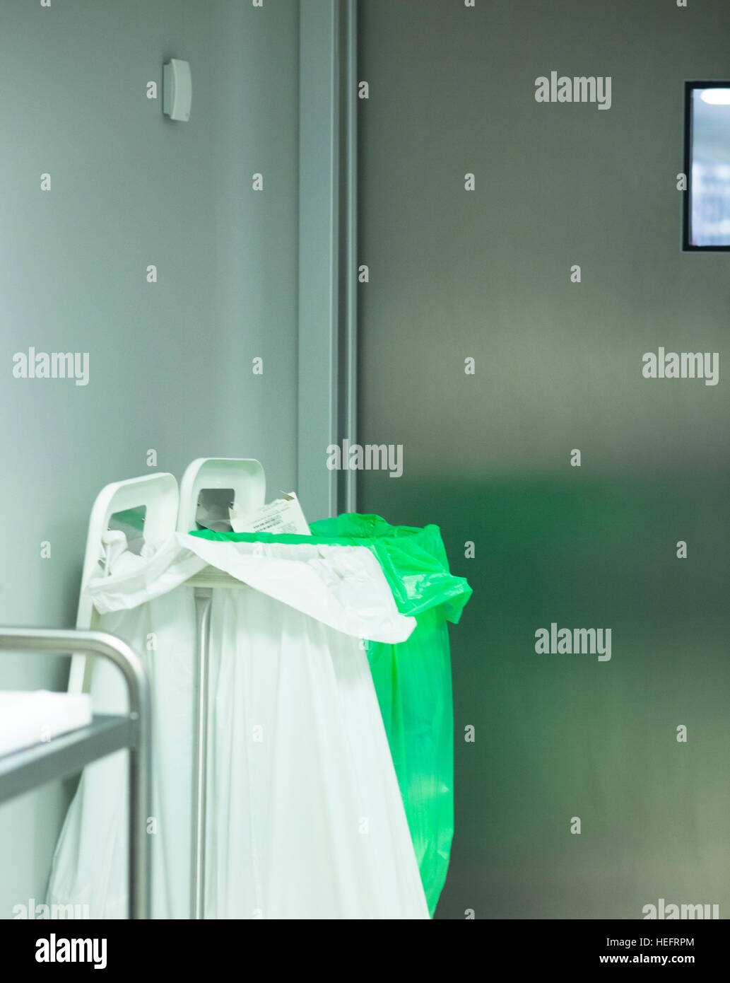 Operating theater surgery trash bin with green plastic bag used to ...