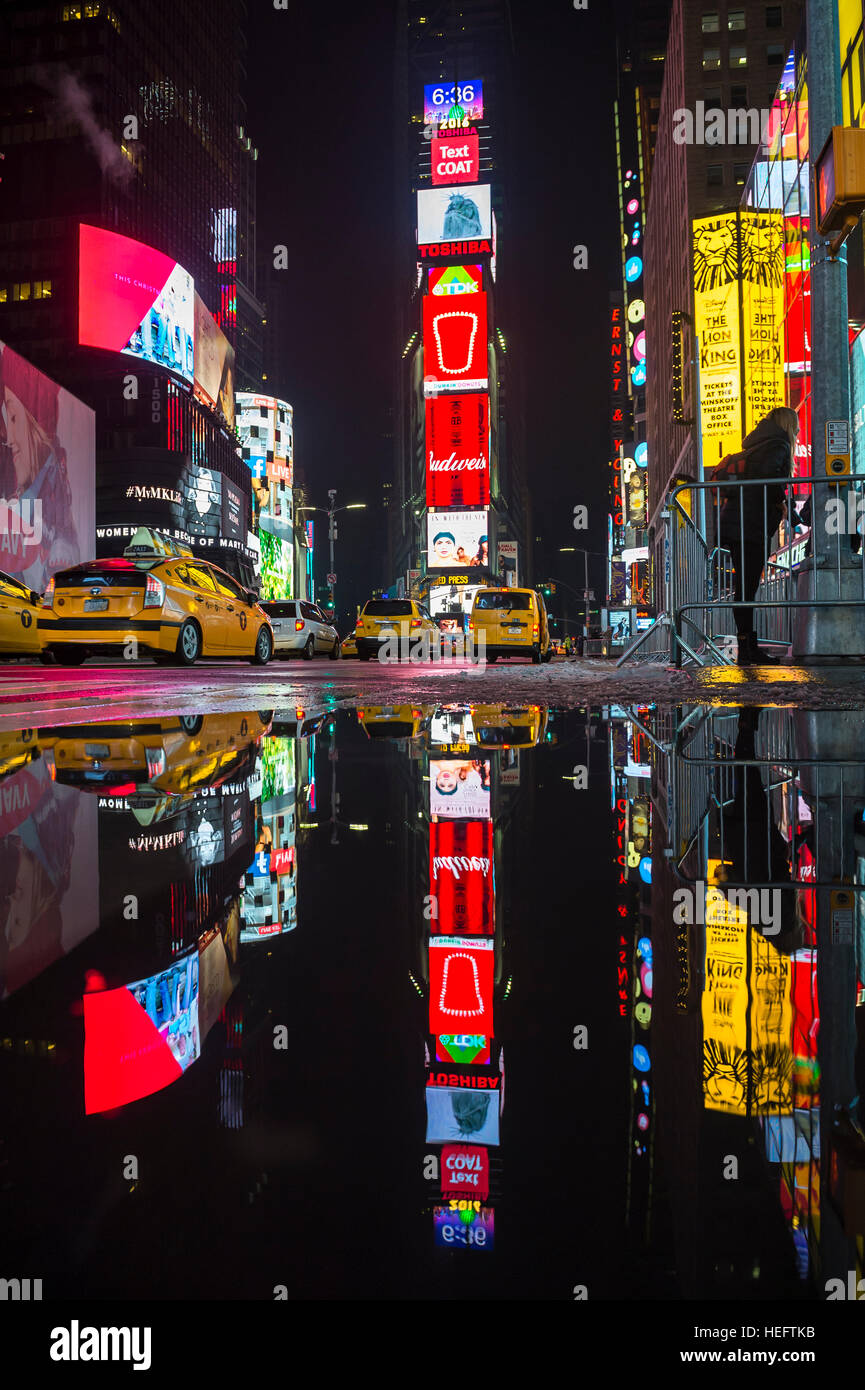 NEW YORK CITY - DECEMBER 19, 2016: Bright advertising signs and yellow ...