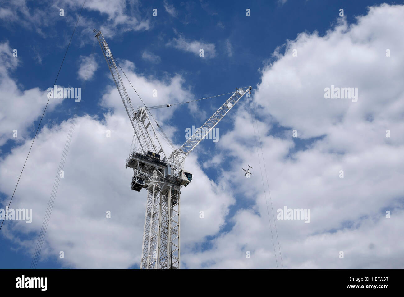 Construction cranes against cloudy sky hi-res stock photography and ...