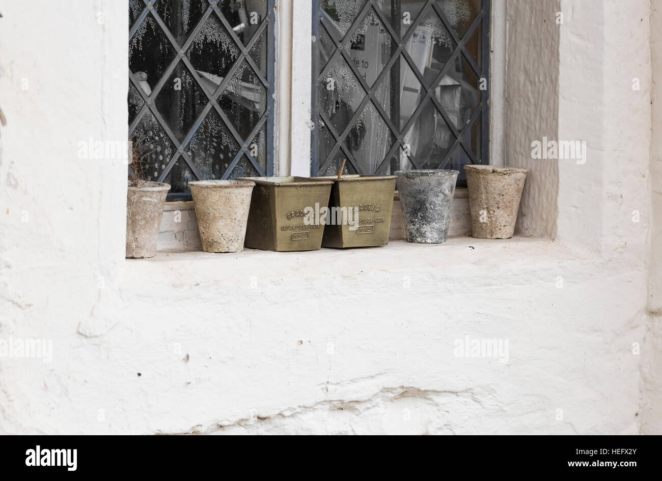 cottage window sill with leaded windows and planters Stock Photo - Alamy