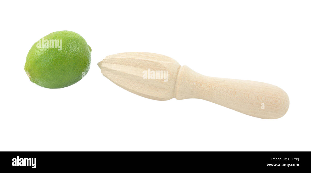 Whole lime and wooden citrus reamer, isolated on a white background ...