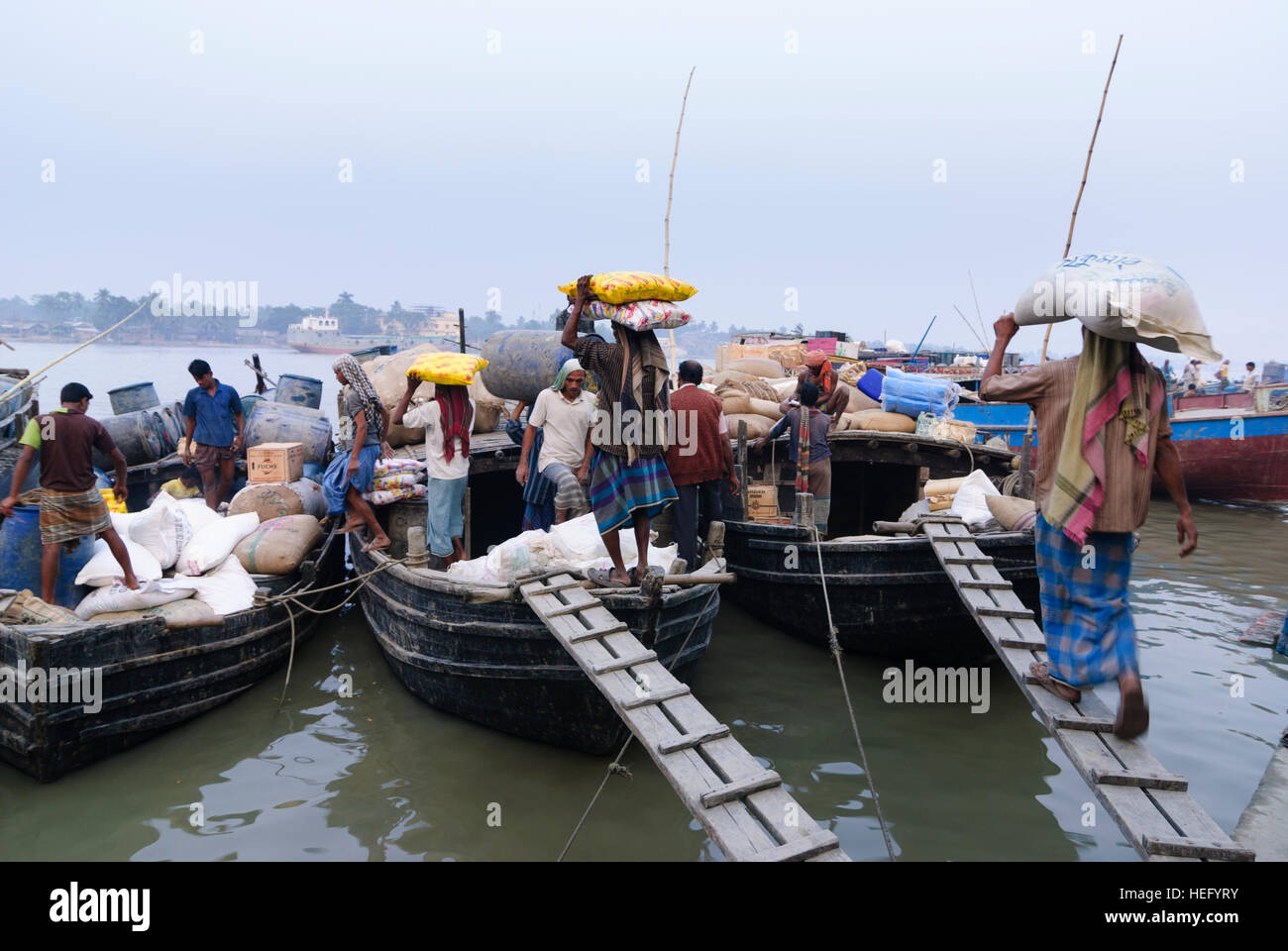 Khulna: Port on the Bhairab river, load carriers with sacks, Khulna ...