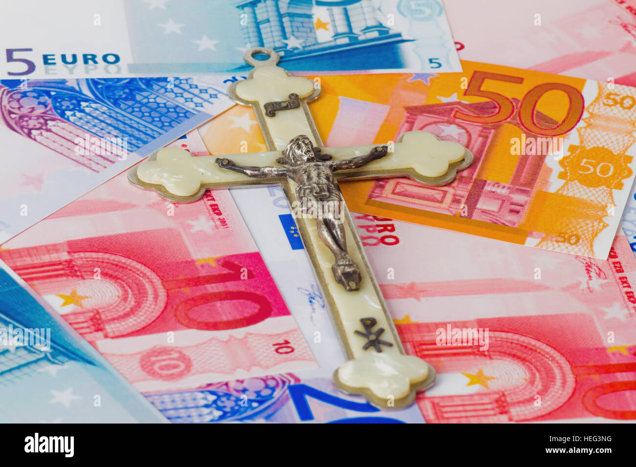 Crucifix on euro banknotes. Shot in studio Stock Photo - Alamy