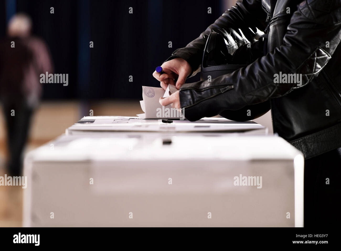 Hand with a stamp casting a vote into the ballot box during elections ...