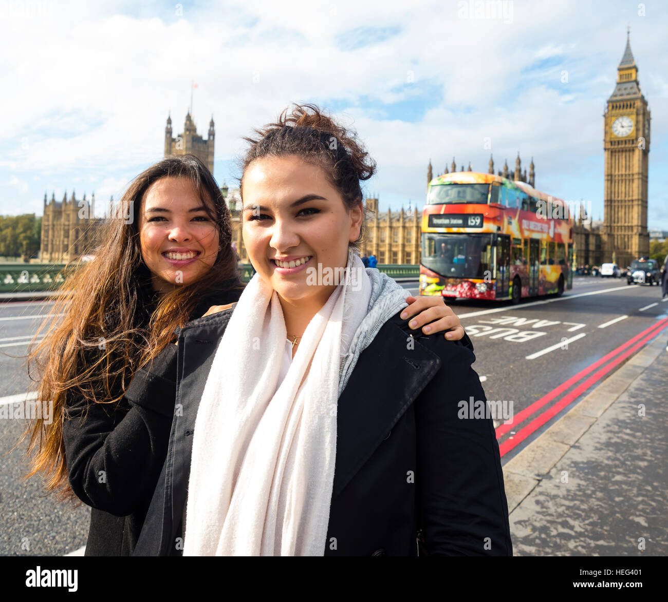 Two girls in front of Big Ben, City of Westminster, London, England ...