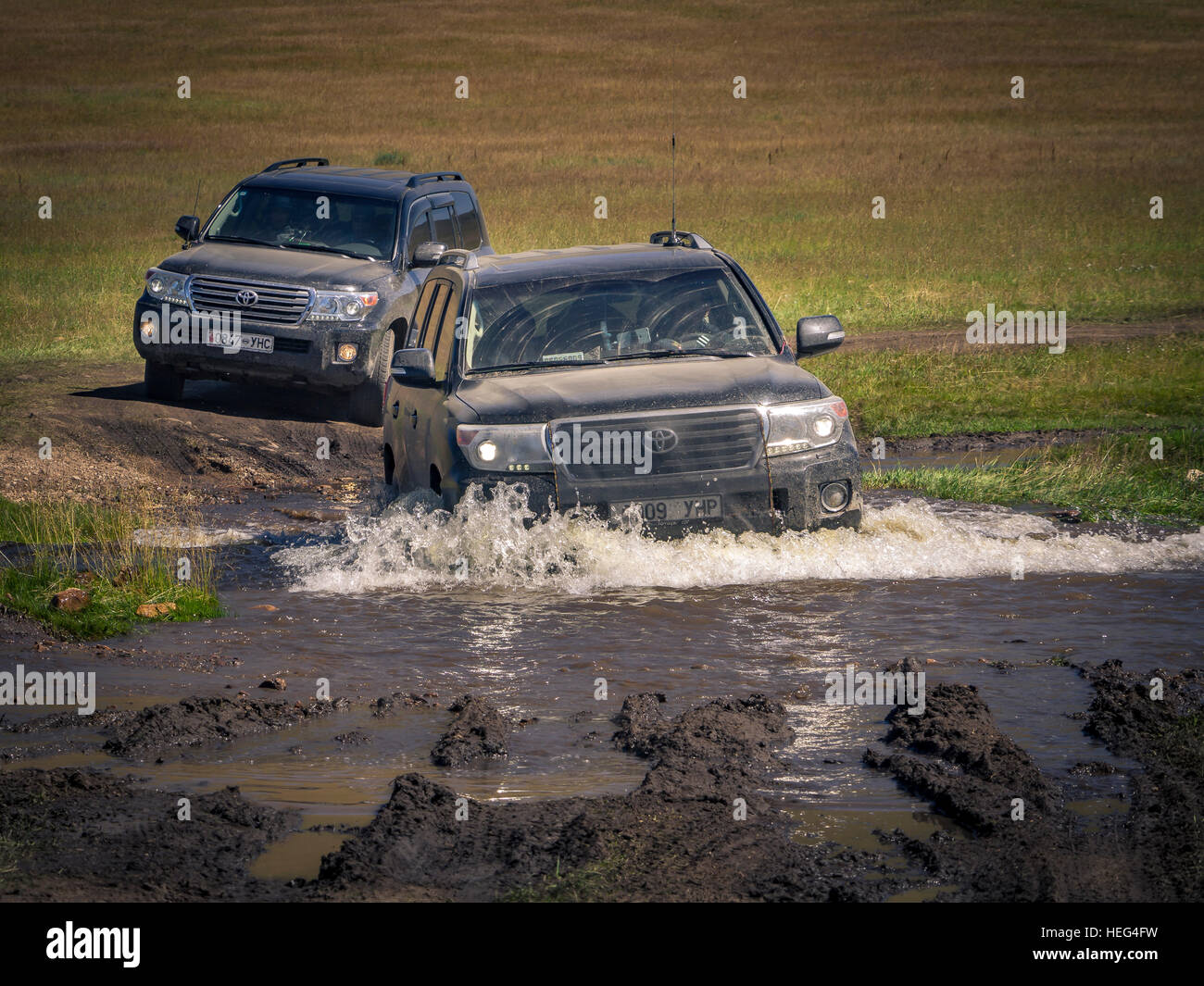 Sport utility vehicles, SUVs crossing river, Mongolia Stock Photo - Alamy
