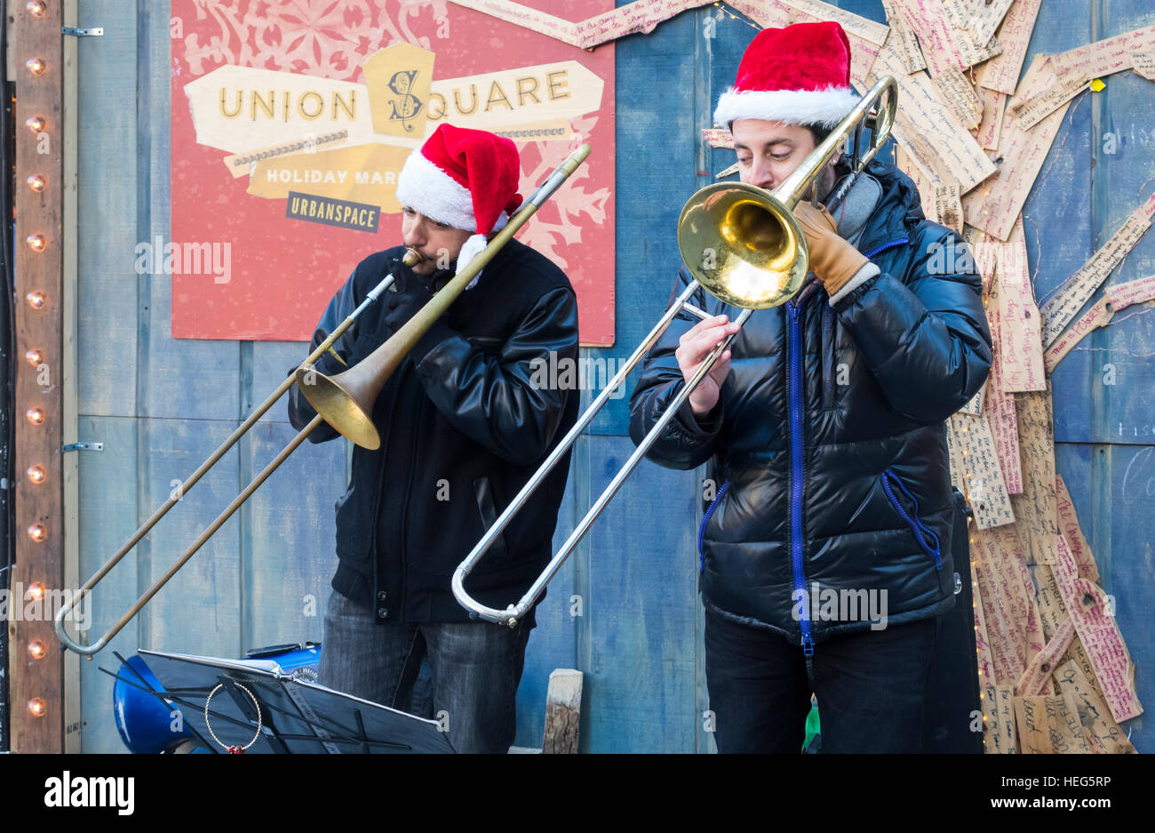 Two trombone players in Union Square in New York City play Christmas ...