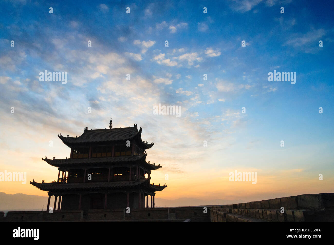 Jiayuguan fort at dusk at the western boundary of the Great Wall of ...