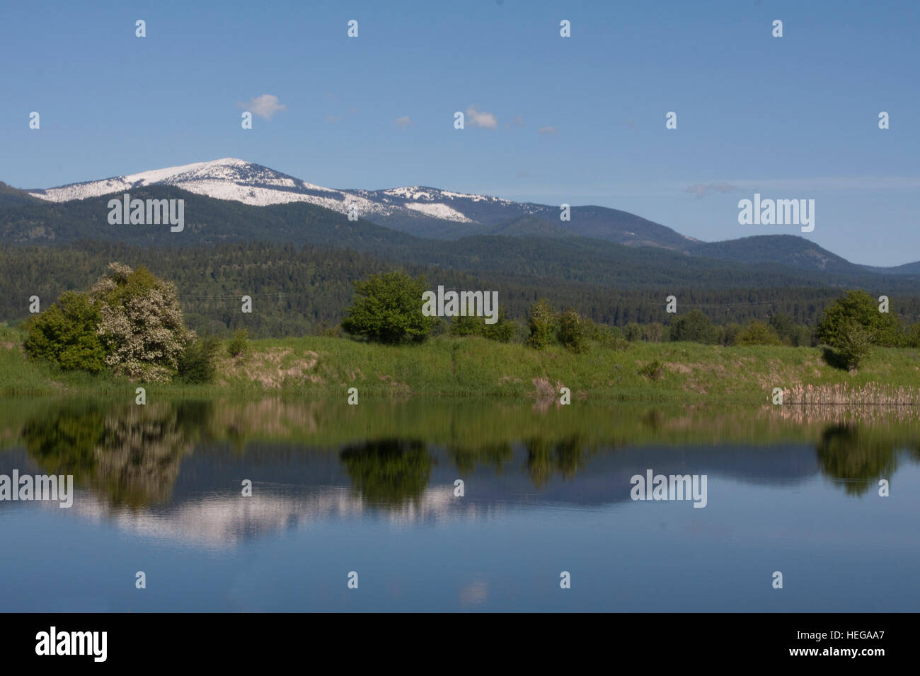 Snow-capped mountain with water reflection Stock Photo - Alamy
