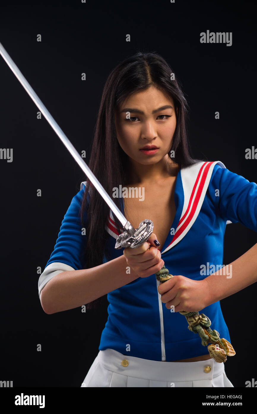 Asian lady with sword in studio Stock Photo - Alamy
