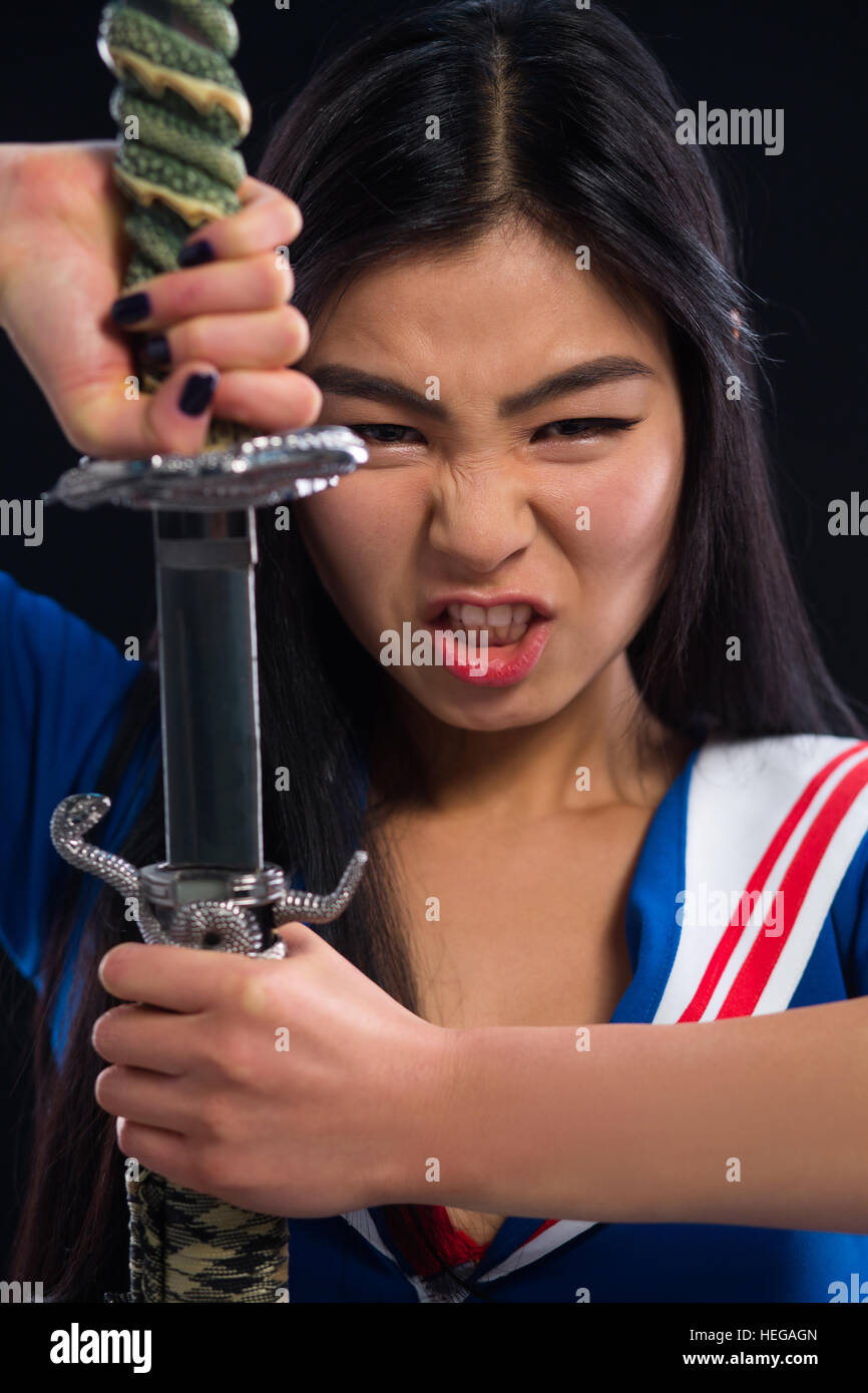 Asian lady with sword in studio Stock Photo - Alamy
