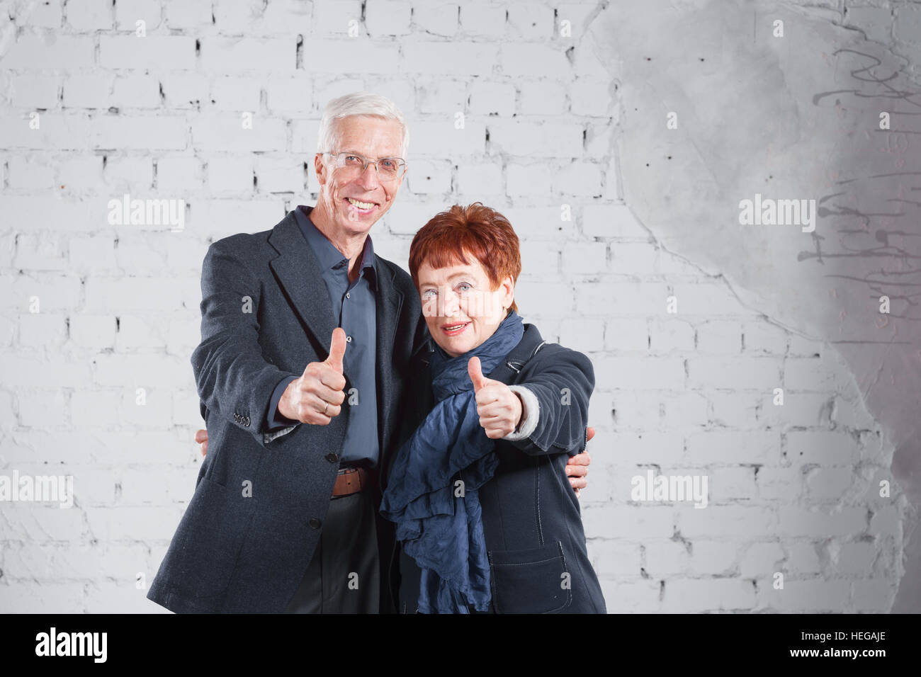 finger to the top, like. Happy smiling old couple standing cuddling ...