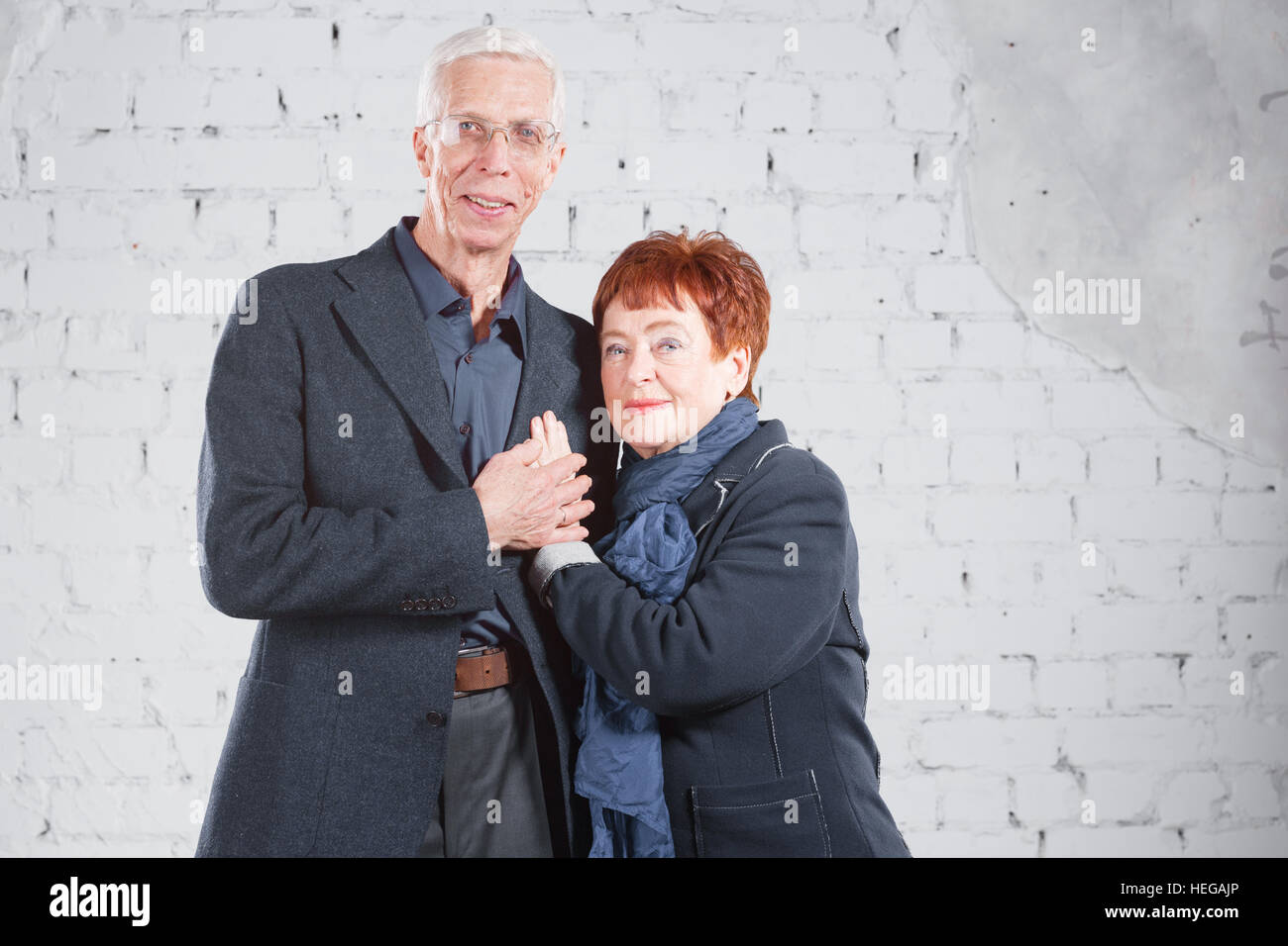 Happy smiling old couple standing cuddling together isolated on white ...