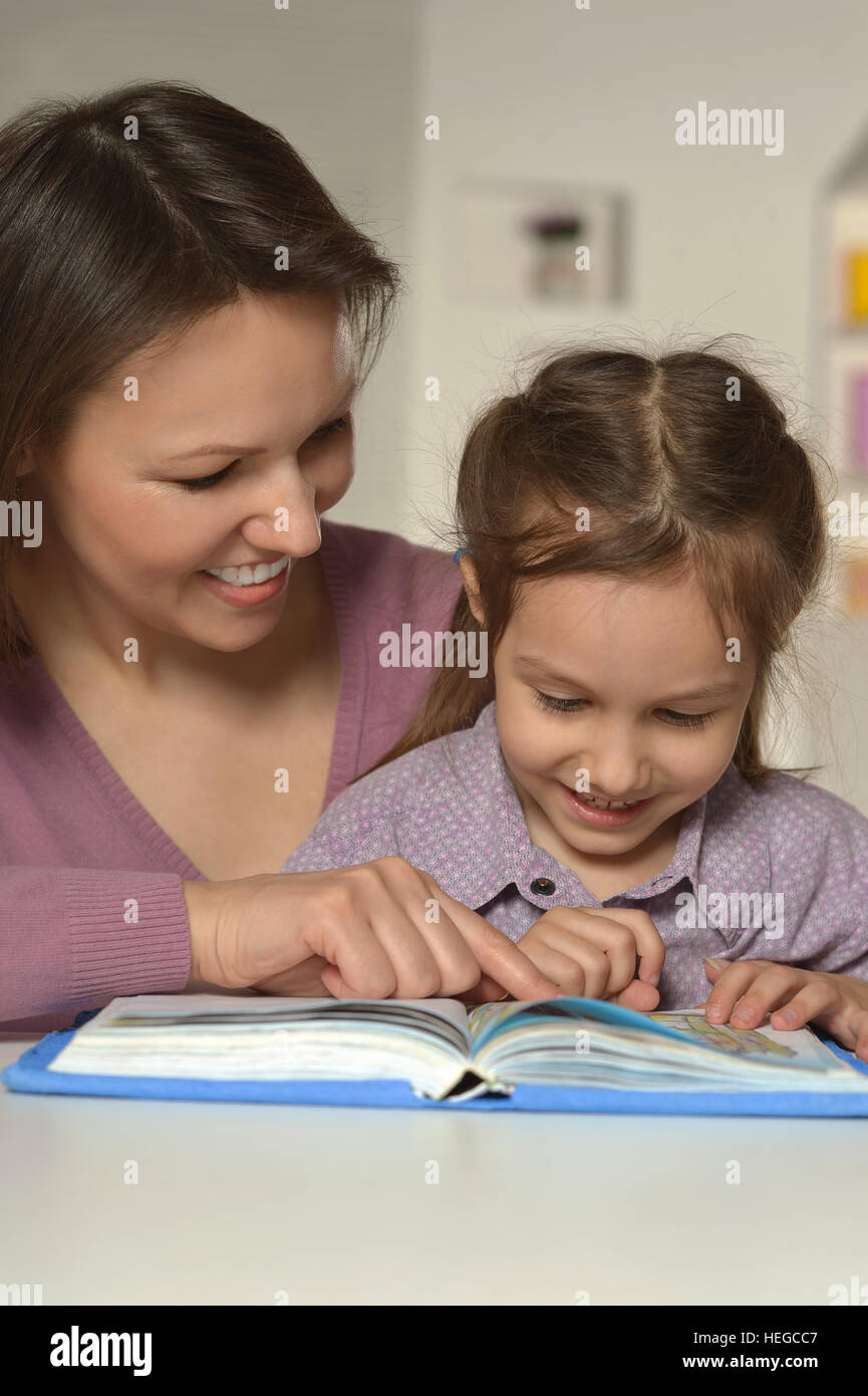 mother doing homework with daughter Stock Photo - Alamy