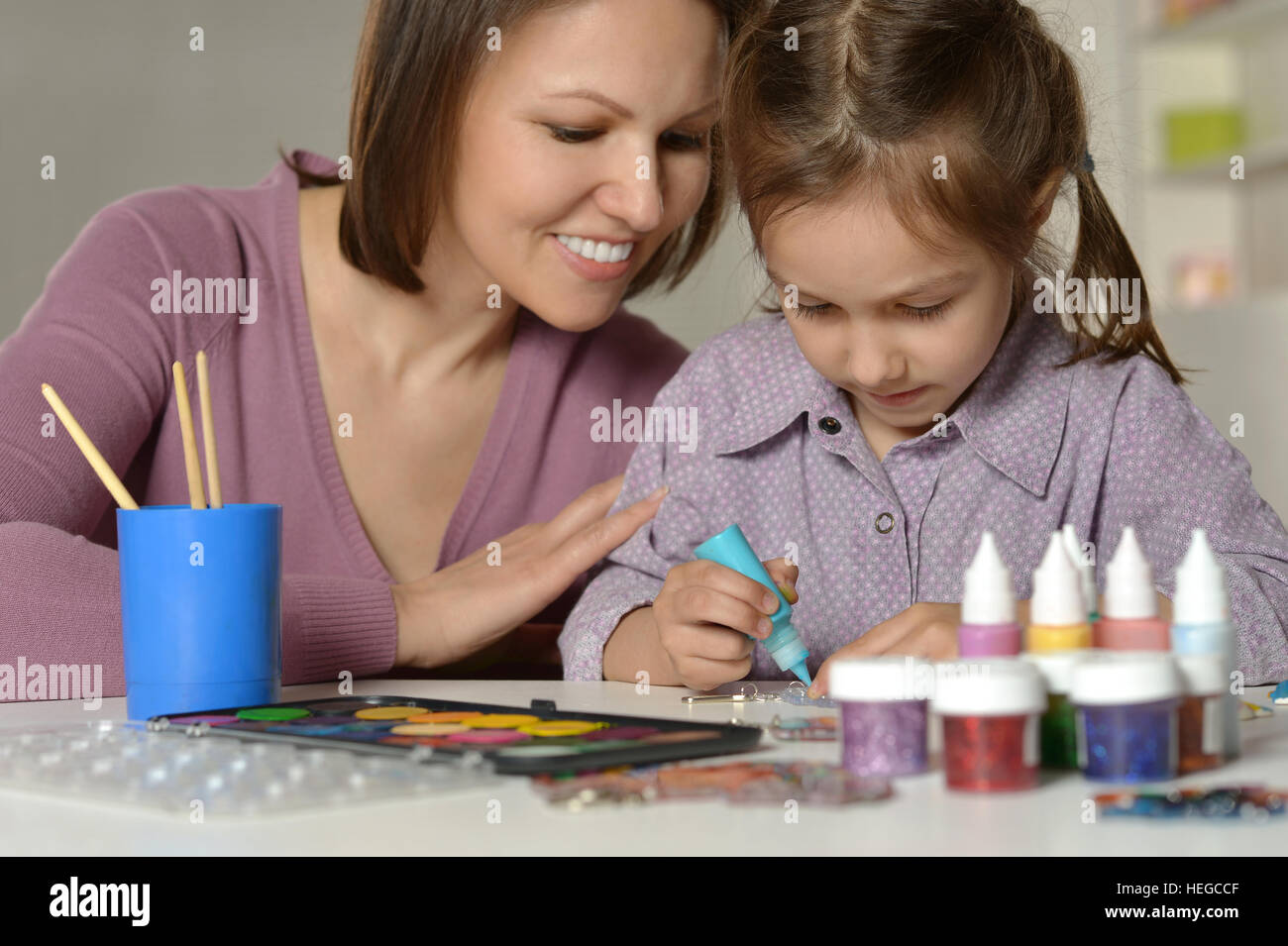 mother doing homework with daughter Stock Photo - Alamy