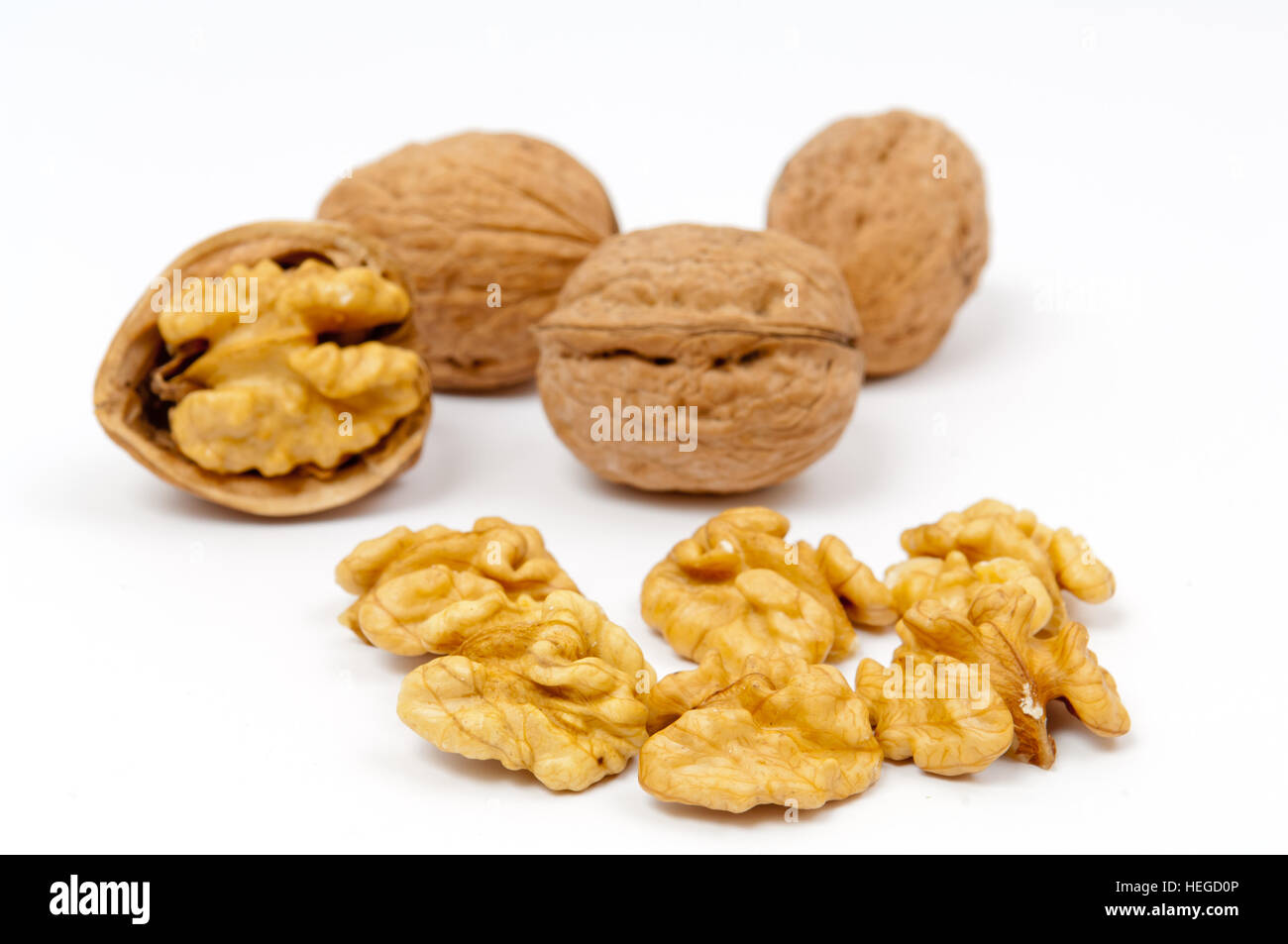 Whole walnuts and walnut kernels on white background Stock Photo - Alamy