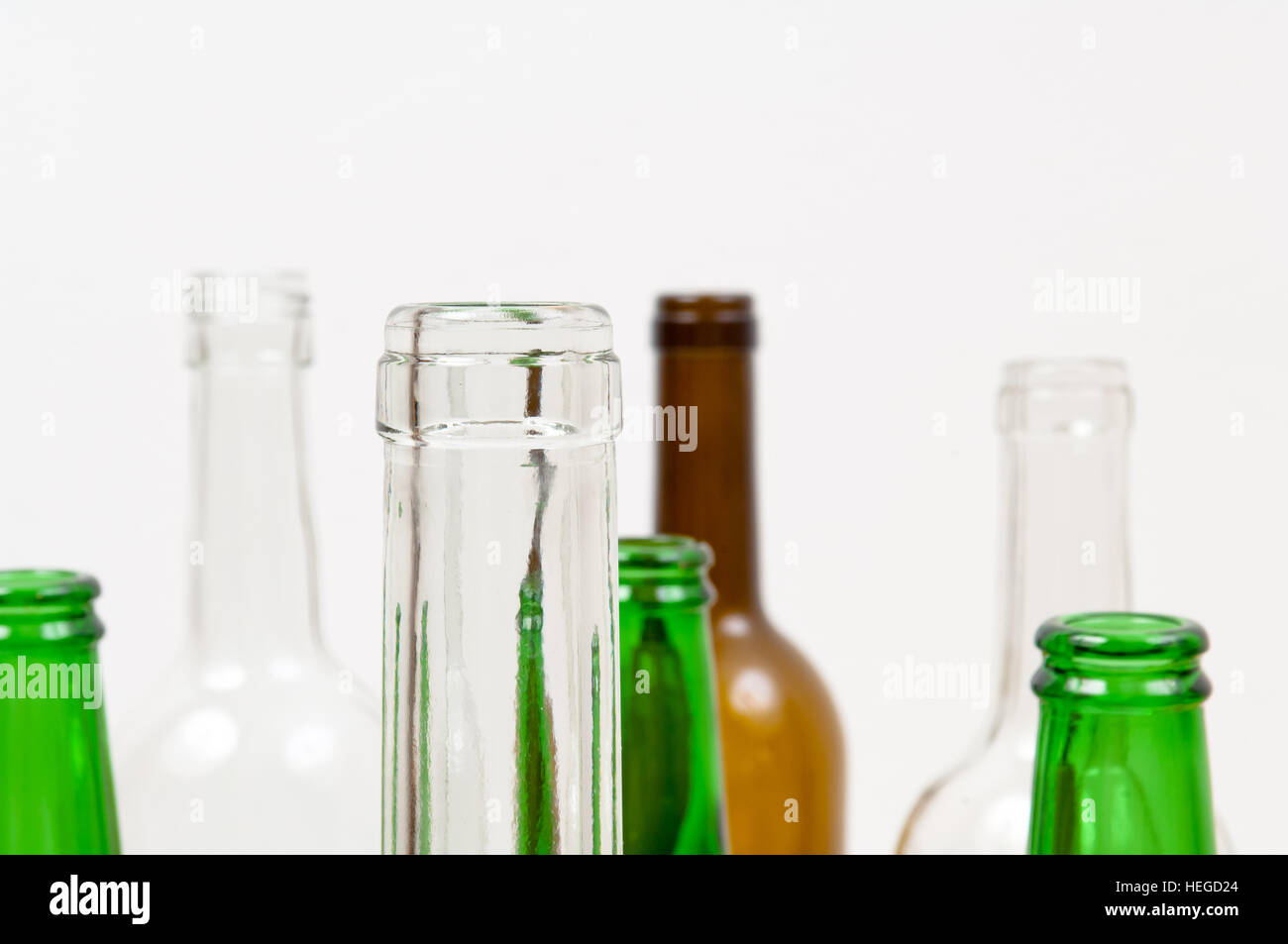 Empty glass bottles of mixed colors including white, green and amber ...