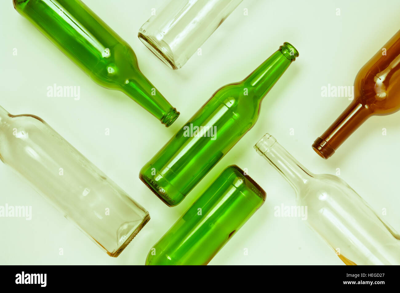 Empty glass bottles of mixed colors including white, green and amber ...