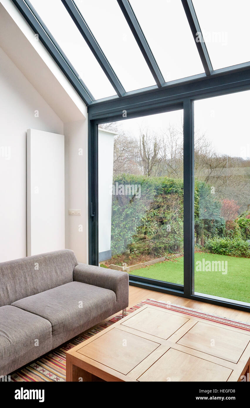 Modern living room with large windows and view on a automnal garden ...
