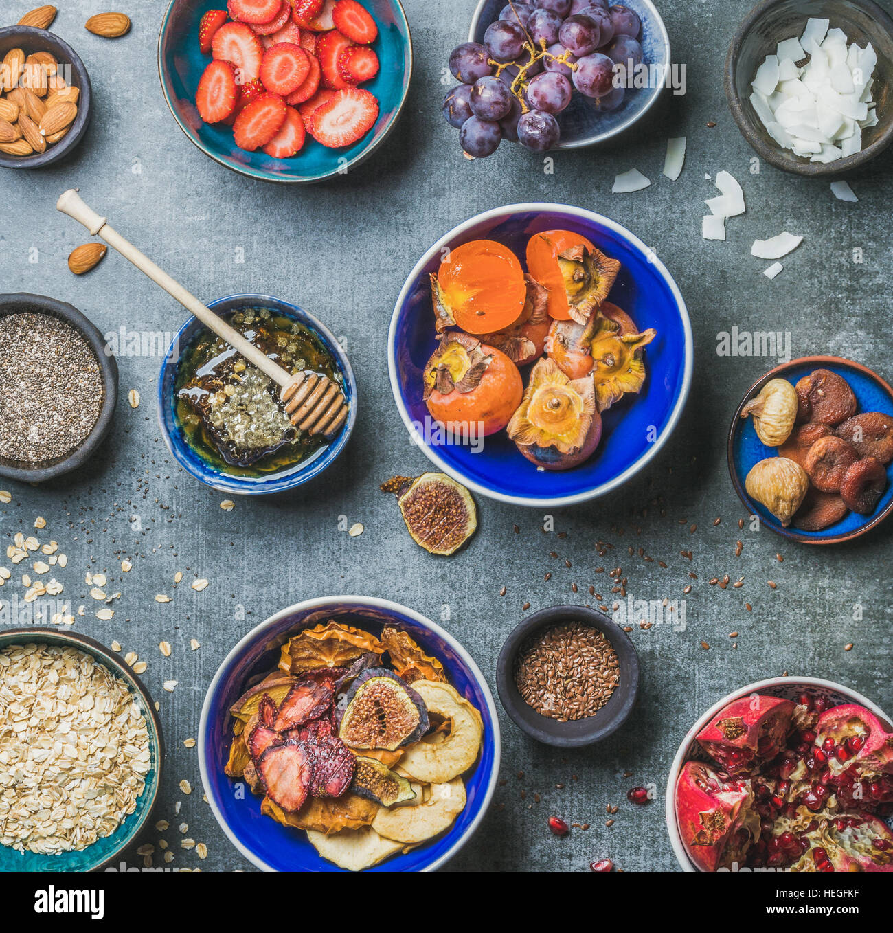 Ingredients for healthy breakfast in bowls over grey stone background ...