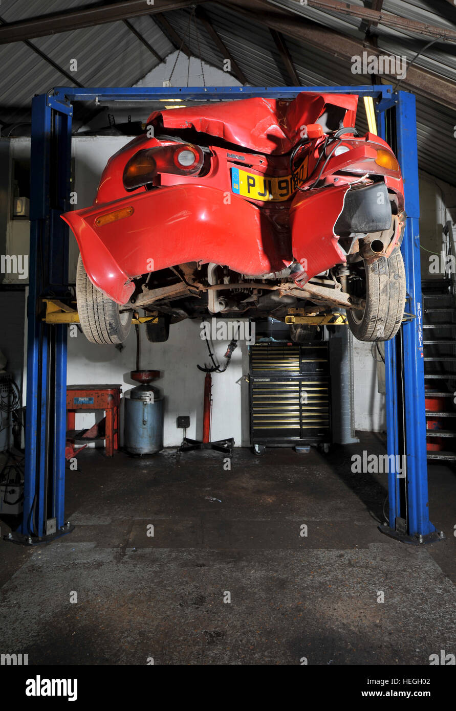 Car wreck. Crash damaged Mk1 Mazda MX5 with the rear bumper folded ...