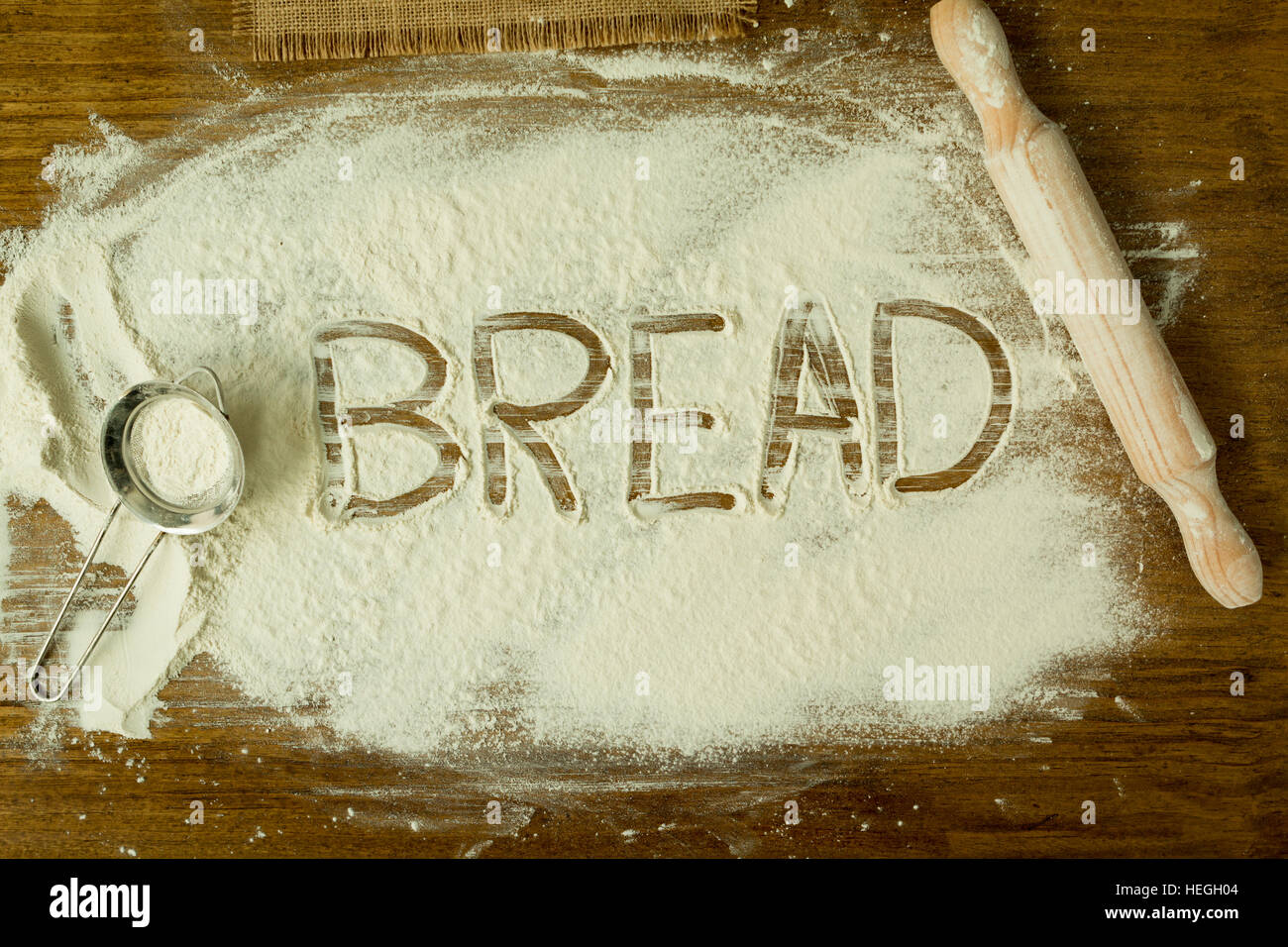 Flour on wooden table word bake hi-res stock photography and images - Alamy