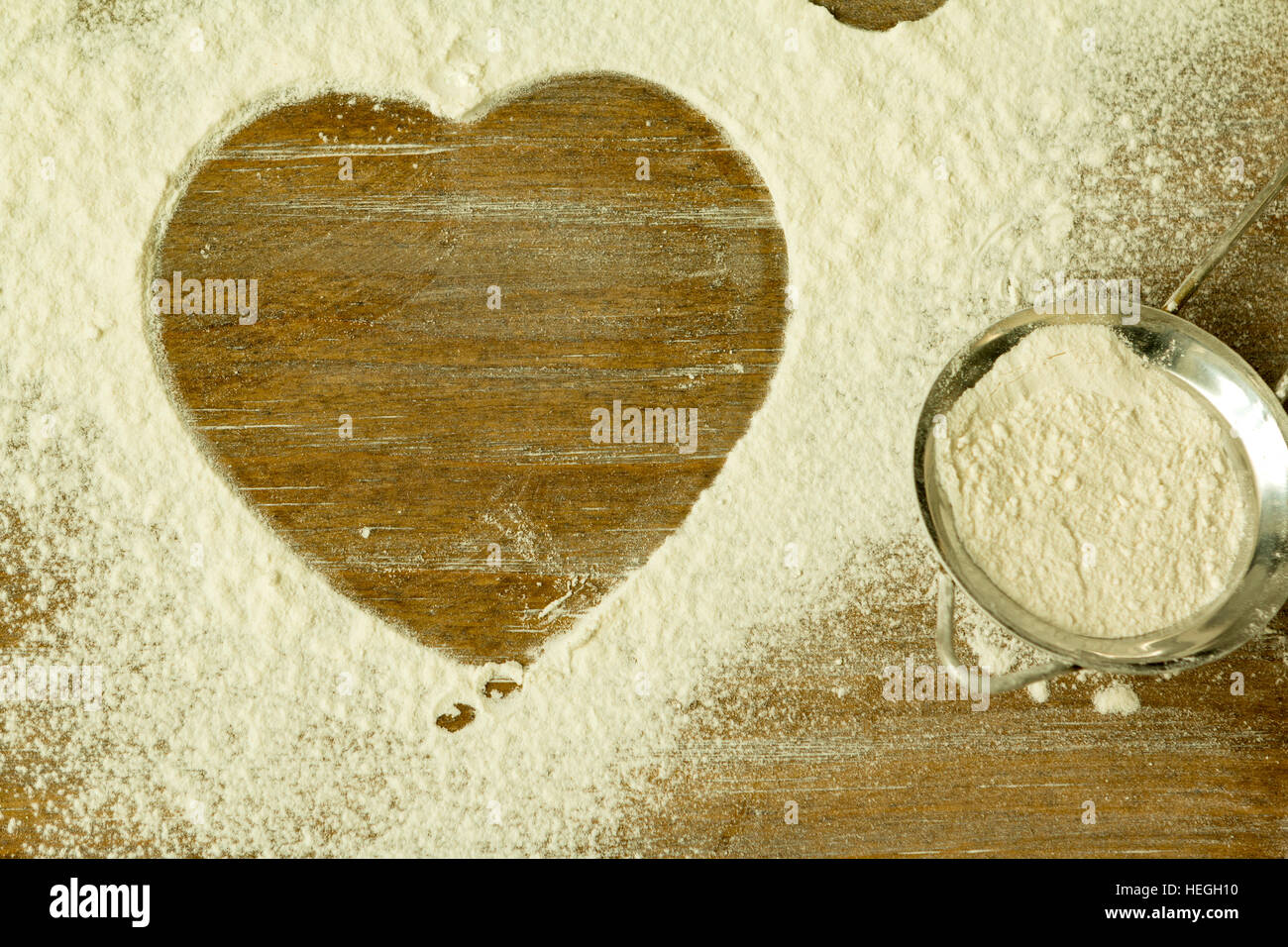 Heart shape in the sifted flour on the table Stock Photo - Alamy