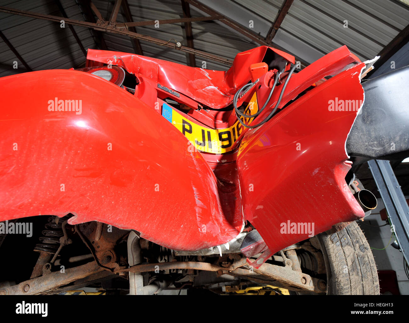 Car wreck. Crash damaged Mk1 Mazda MX5 with the rear bumper folded ...