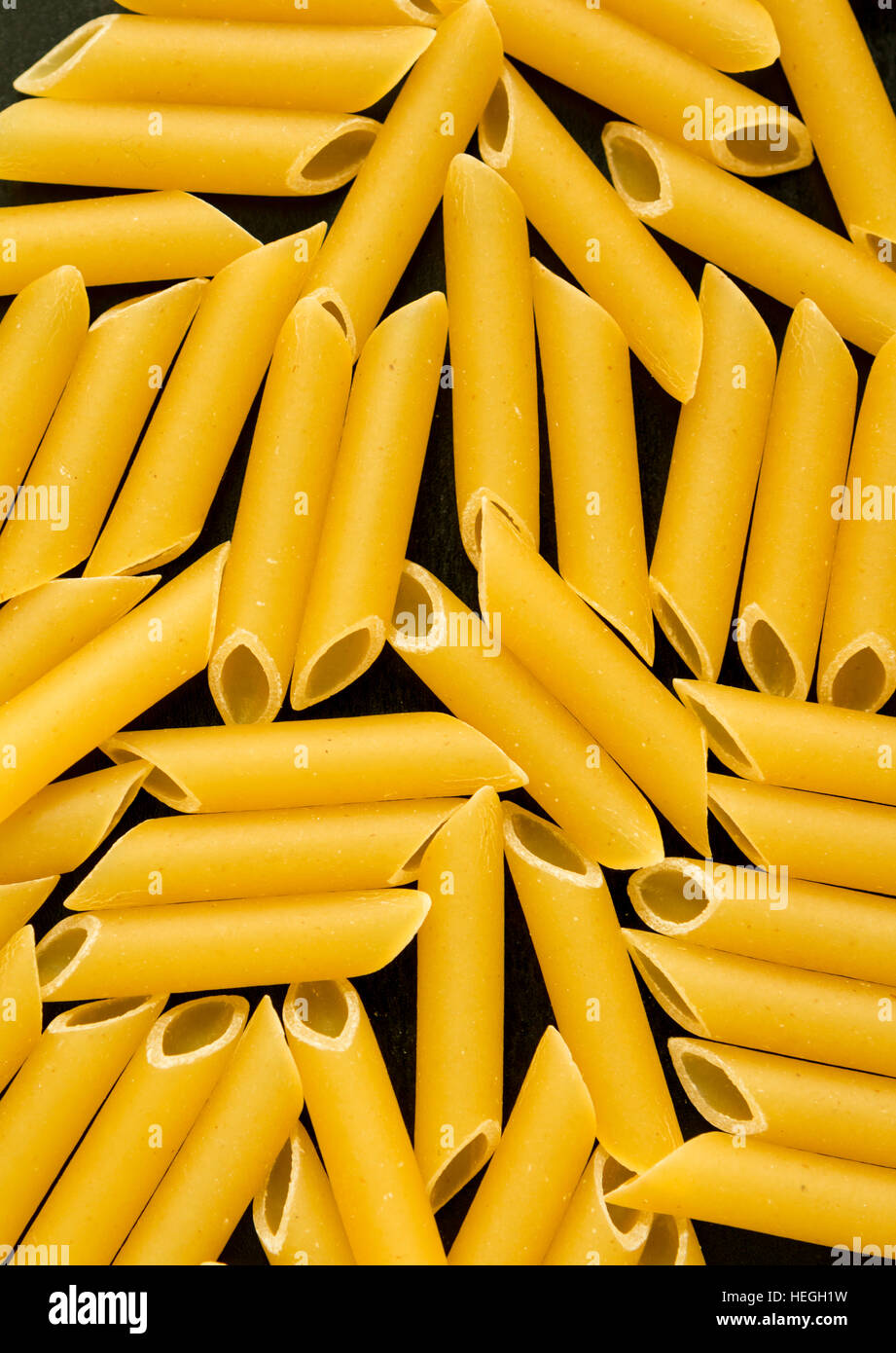 Italian Macaroni Pasta raw close up on a black background Stock Photo ...