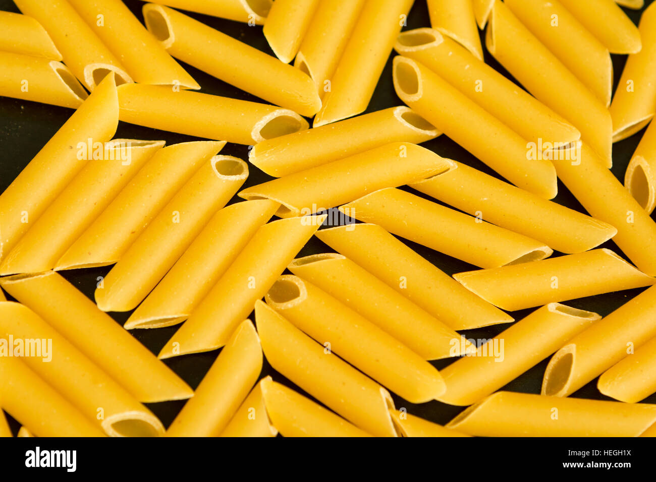 Italian Macaroni Pasta raw close up on a black background Stock Photo ...