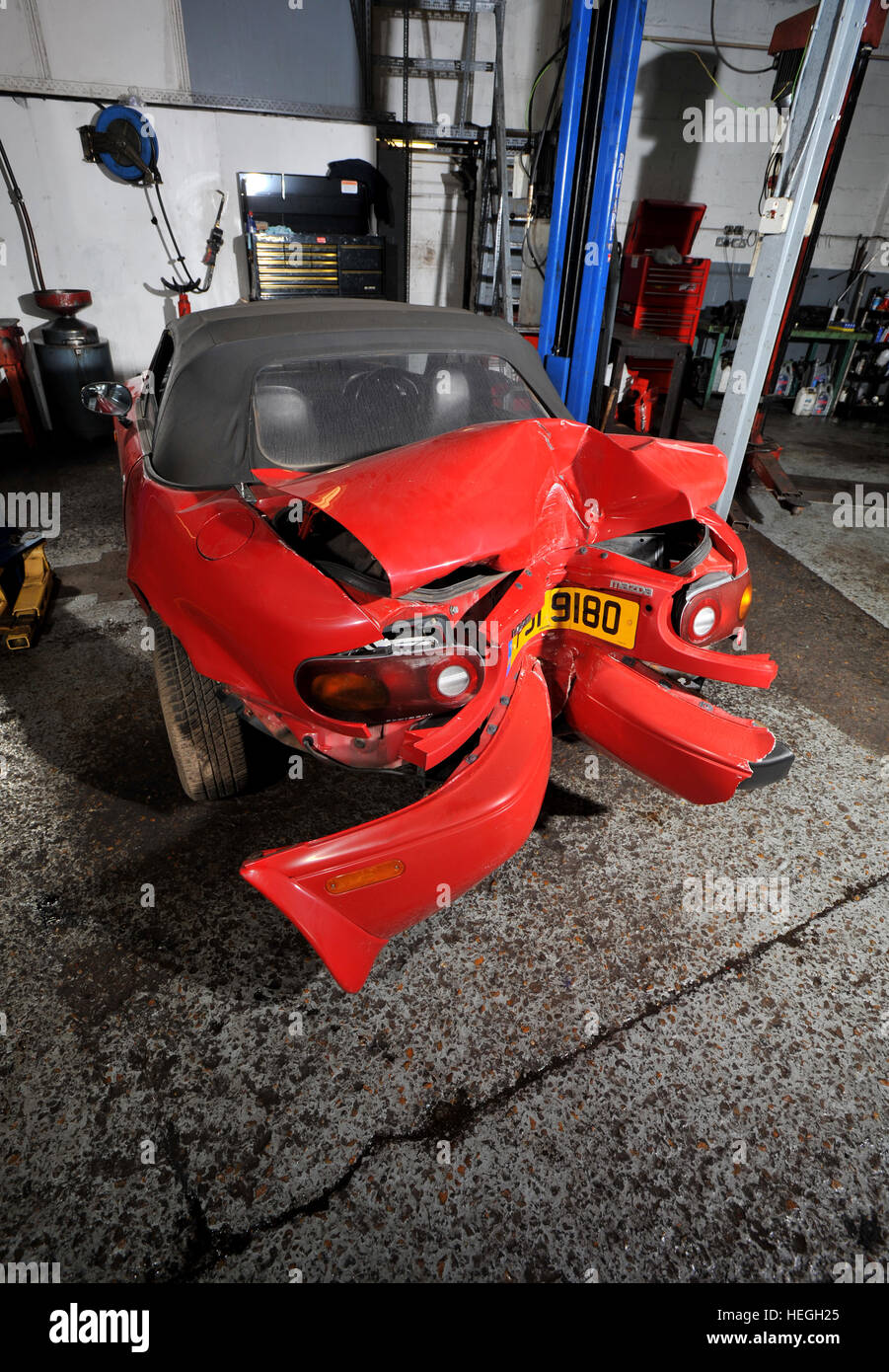 Car wreck. Crash damaged Mk1 Mazda MX5 with the rear bumper folded ...
