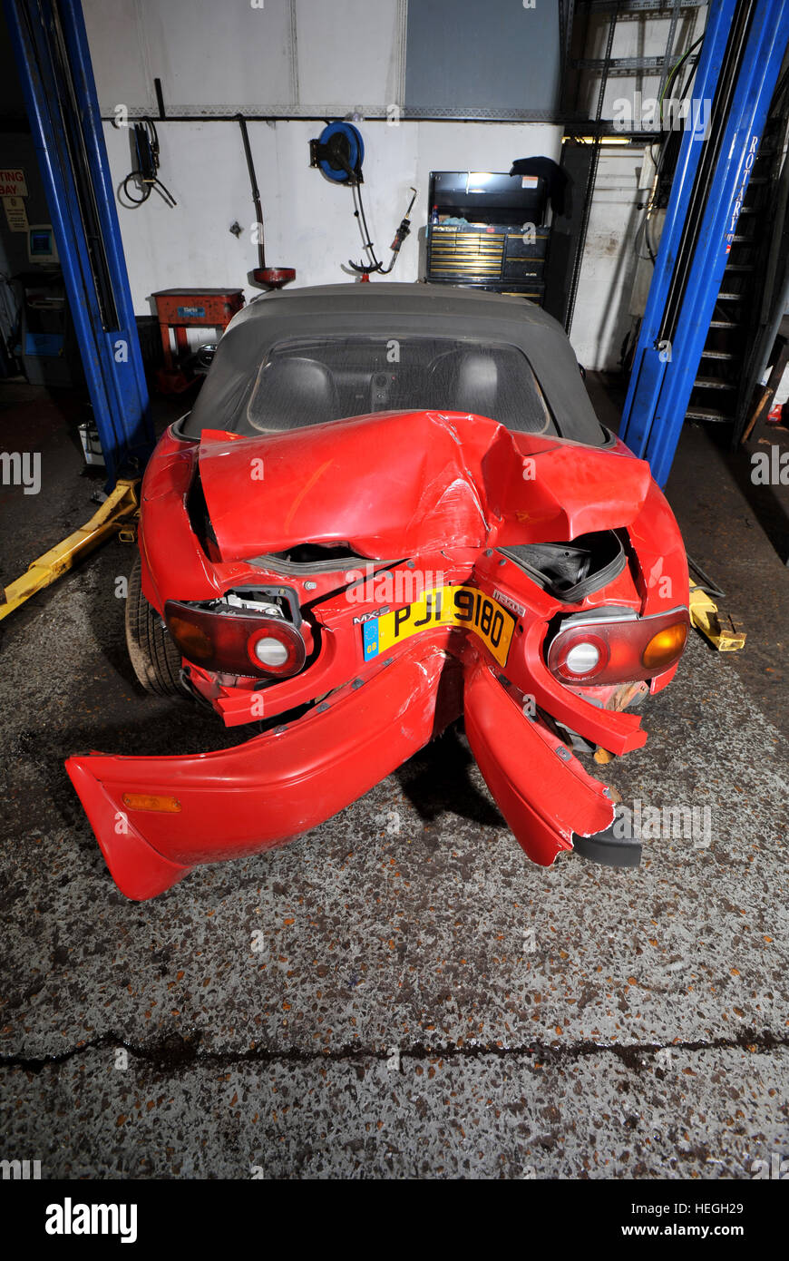 Car wreck. Crash damaged Mk1 Mazda MX5 with the rear bumper folded ...