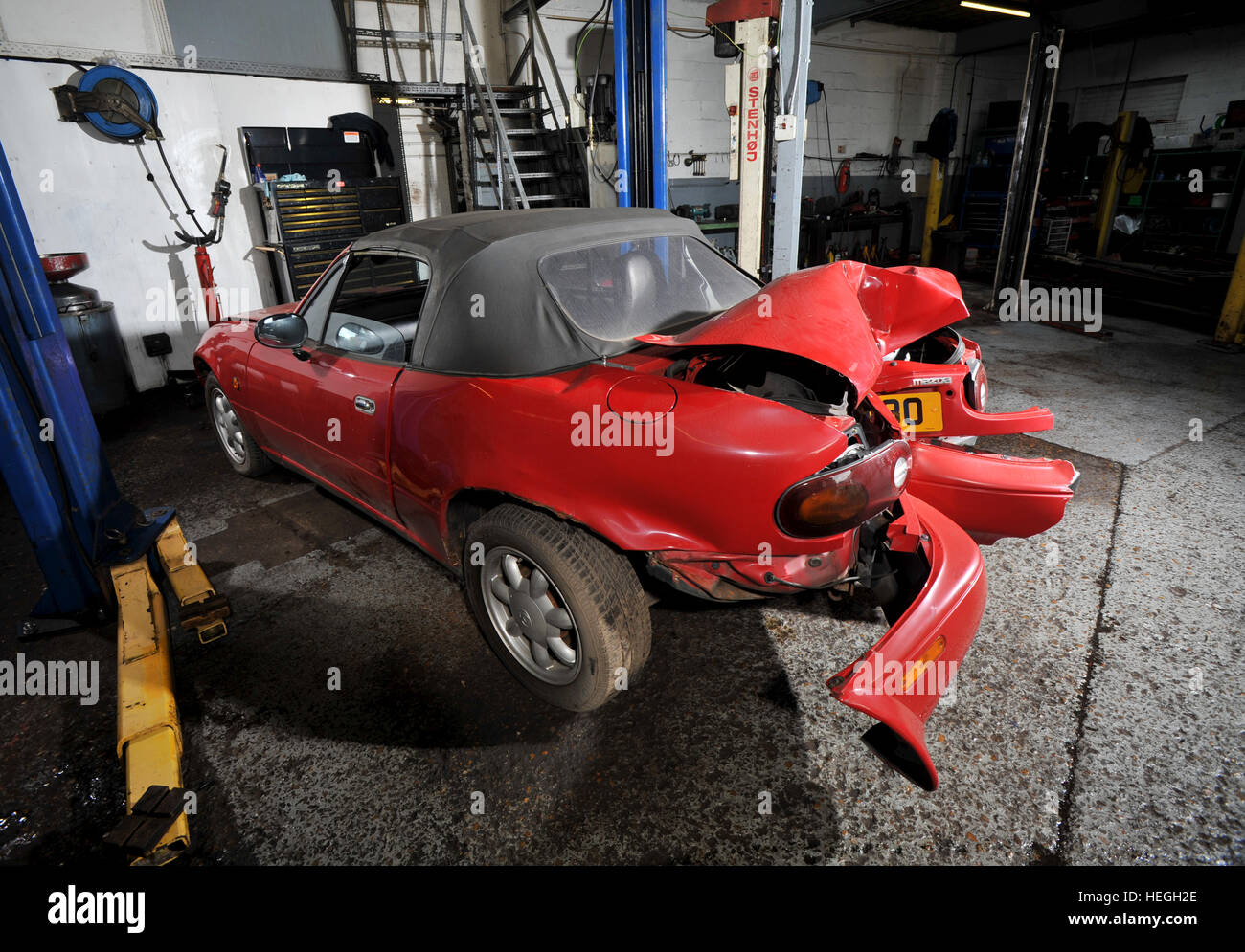 Car wreck. Crash damaged Mk1 Mazda MX5 with the rear bumper folded ...