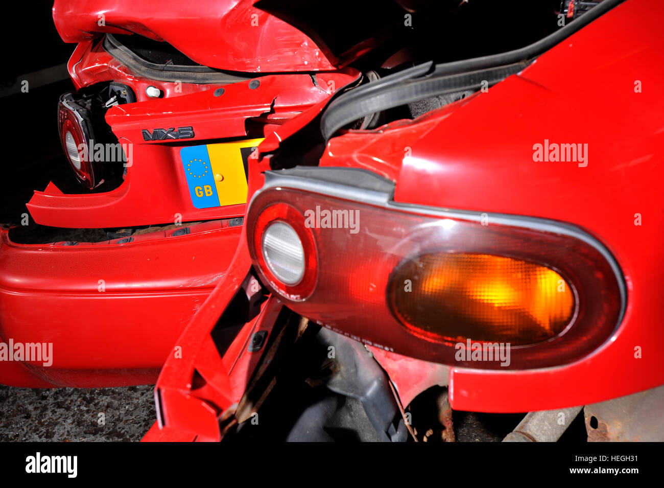 Car wreck. Crash damaged Mk1 Mazda MX5 with the rear bumper folded ...