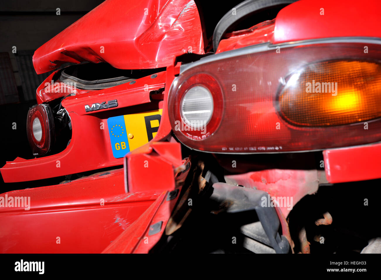 Car wreck. Crash damaged Mk1 Mazda MX5 with the rear bumper folded ...
