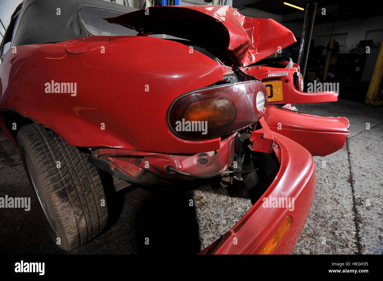 Car wreck. Crash damaged Mk1 Mazda MX5 with the rear bumper folded ...